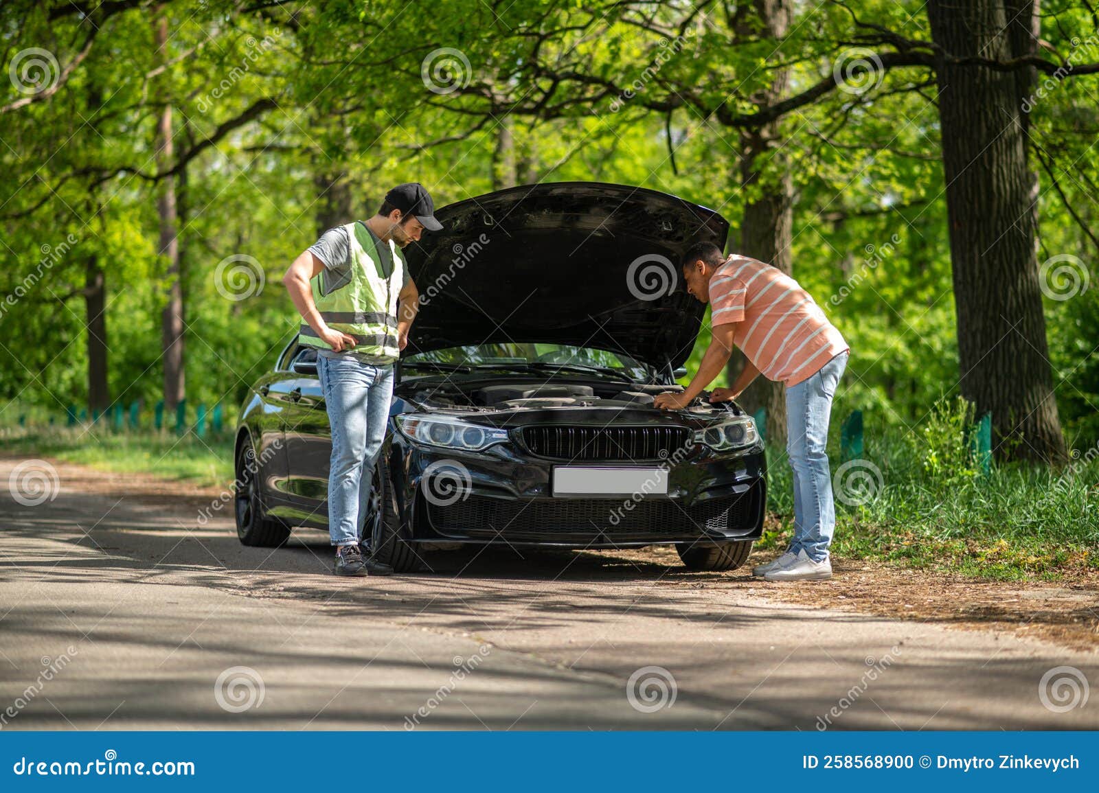 A Driver Discussing a Car Accident with a Service Man and Looking ...
