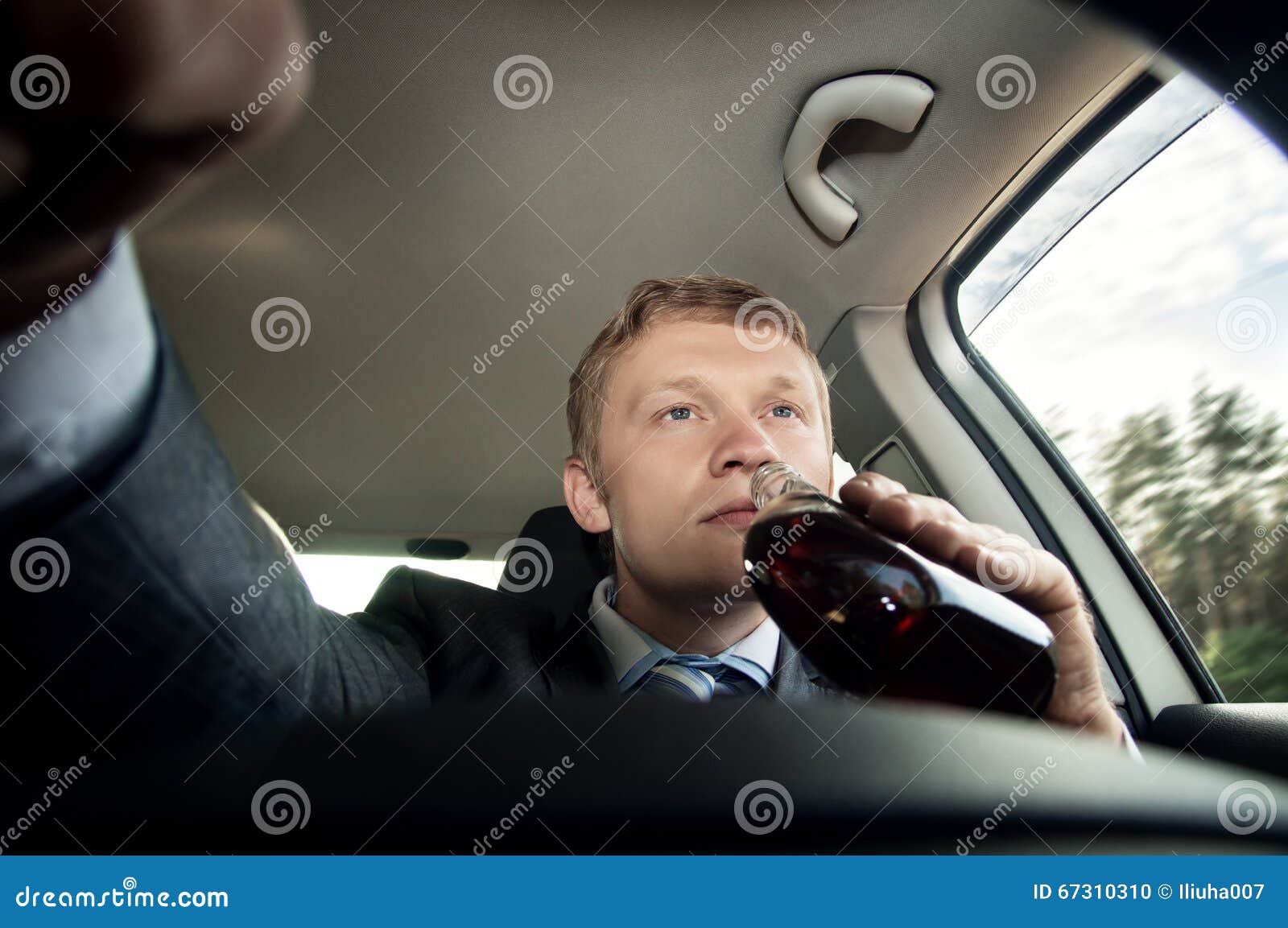 Driver Drinks Alcohol while Driving Stock Photo - Image of automobile ...