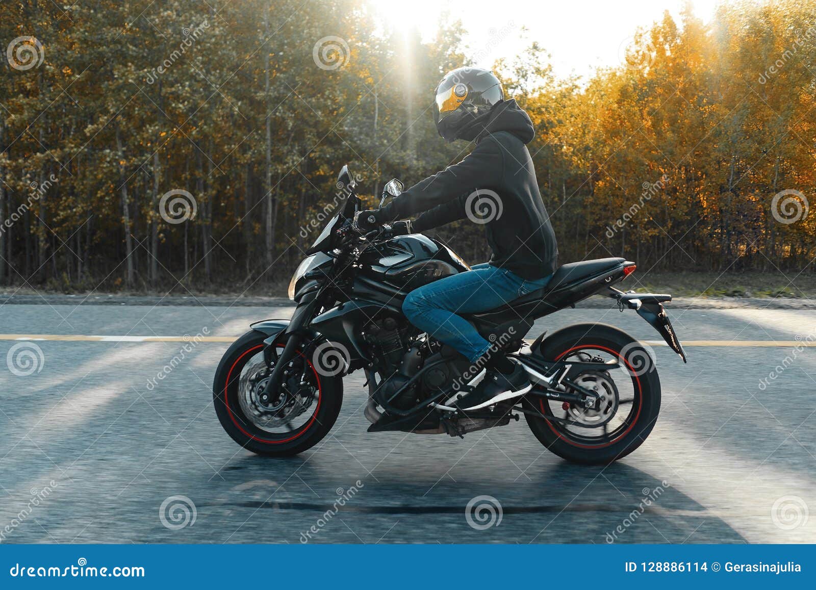 Driver Riding Motorcycle on Empty Road in Beautiful Autumn Forest ...