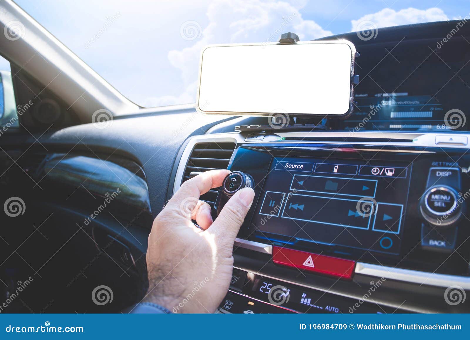 The Driver`s Hand Adjust To Volume Button of Car Audio and a White ...