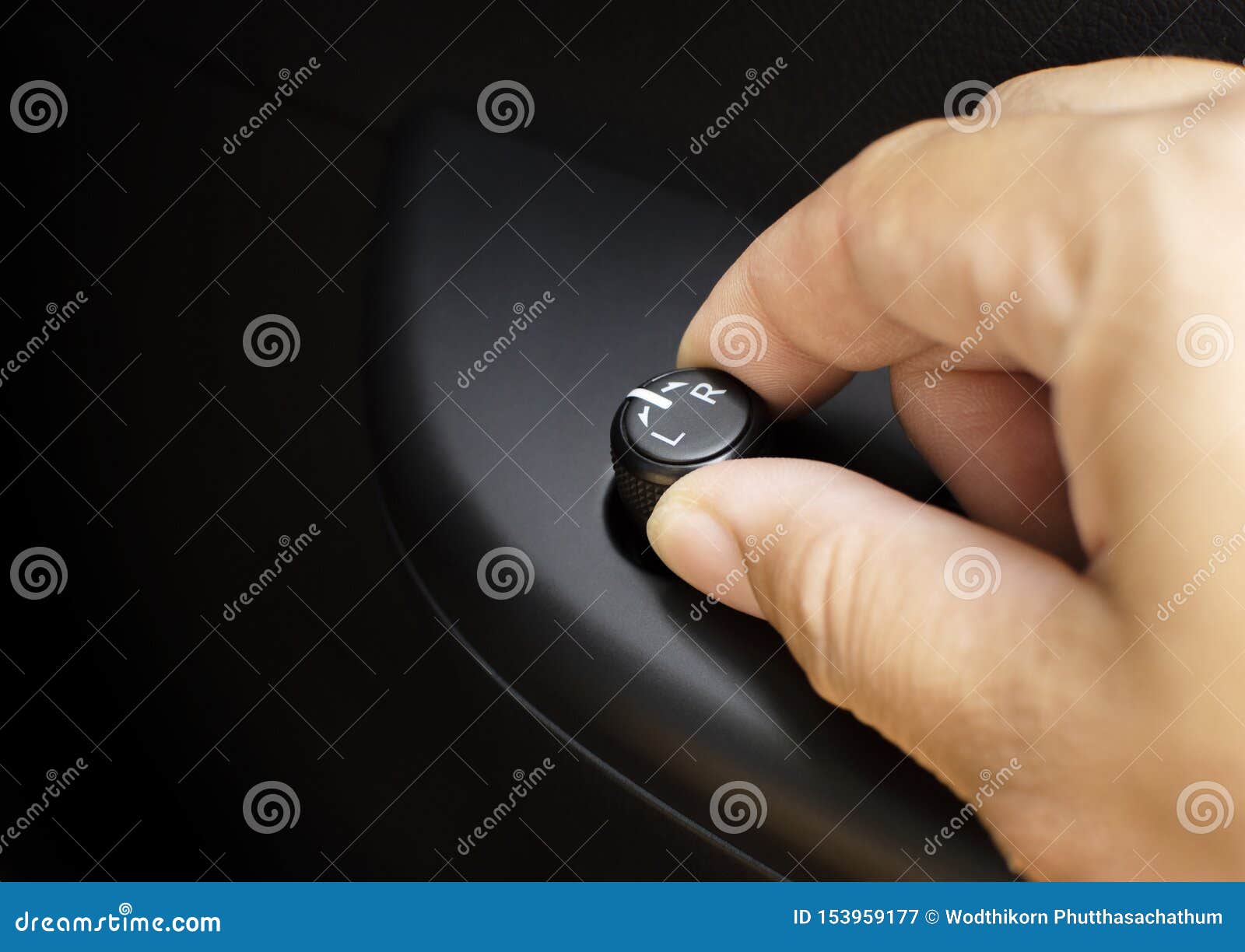 The Driver`s Hand Adjusts the Wing Mirror Direction Control Switch ...