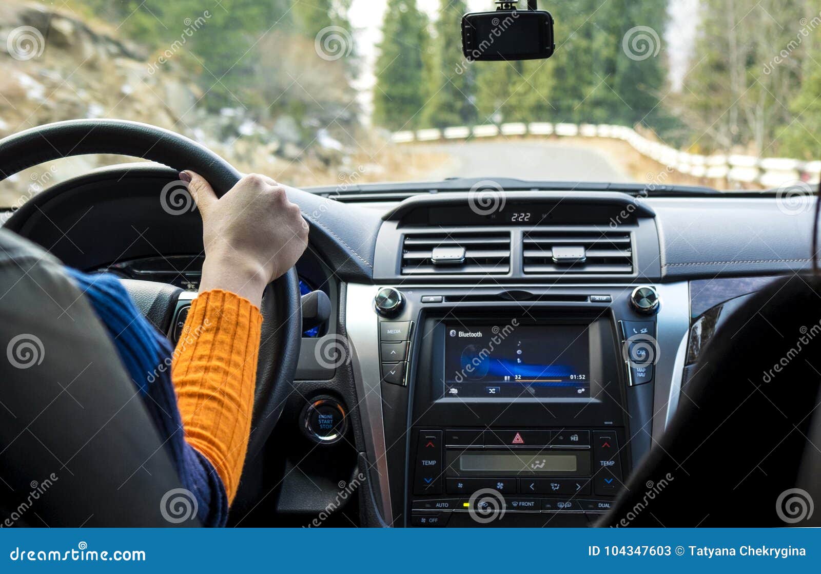Driver`s Hand on the Steering Wheel Inside a Car on a Mountain Road ...