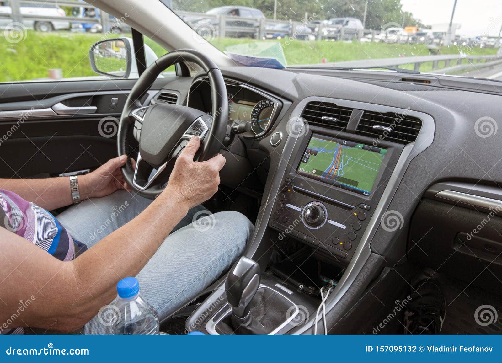 Driver Sits Behind the Wheel of a Car and Rides on a Busy Highway Stock ...