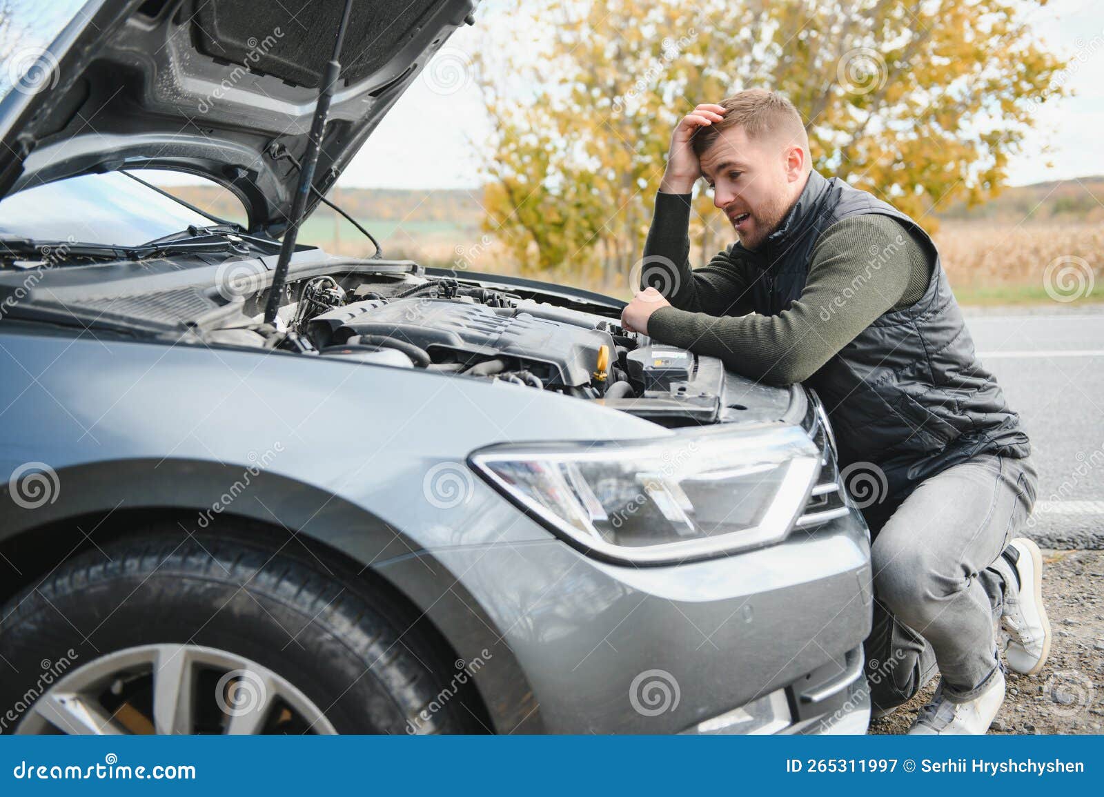Driver Trying To Figure Out How To Fix Broken Down Car with Red ...