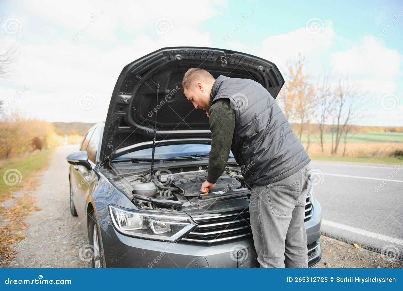 Driver Trying To Figure Out How To Fix Broken Down Car with Red ...