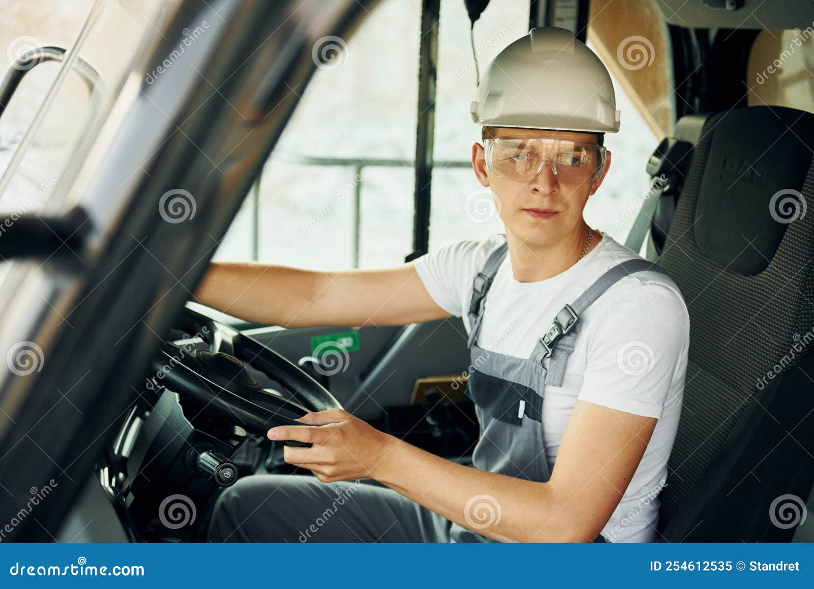 Driver is at Work. Man in Professional Uniform is on the Borrow Pit at ...