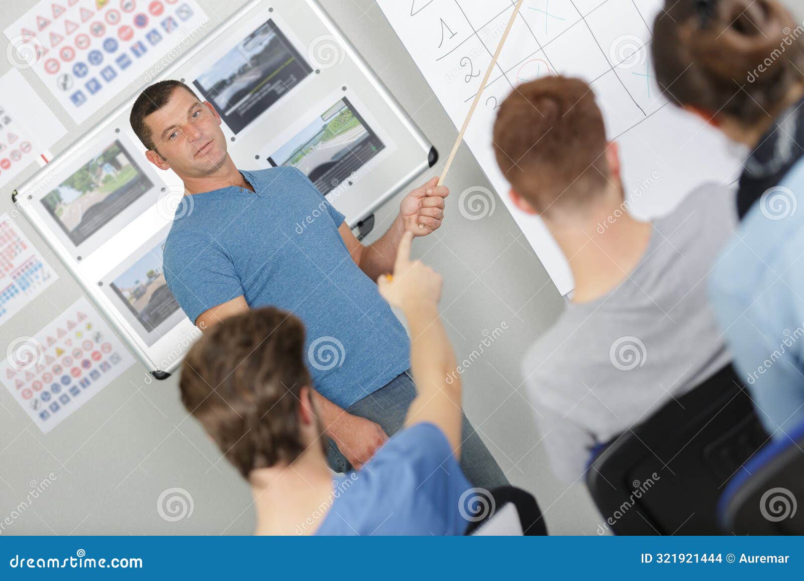 Driving Instructor Pointing at Board in Classroom Stock Photo - Image ...