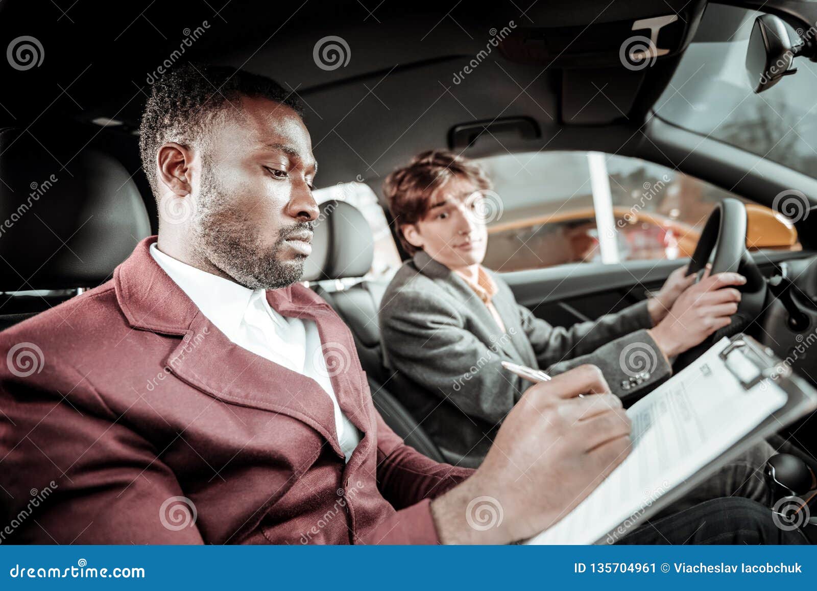 Driving Instructor Wearing Dark Red Jacket Putting Marks for Student ...