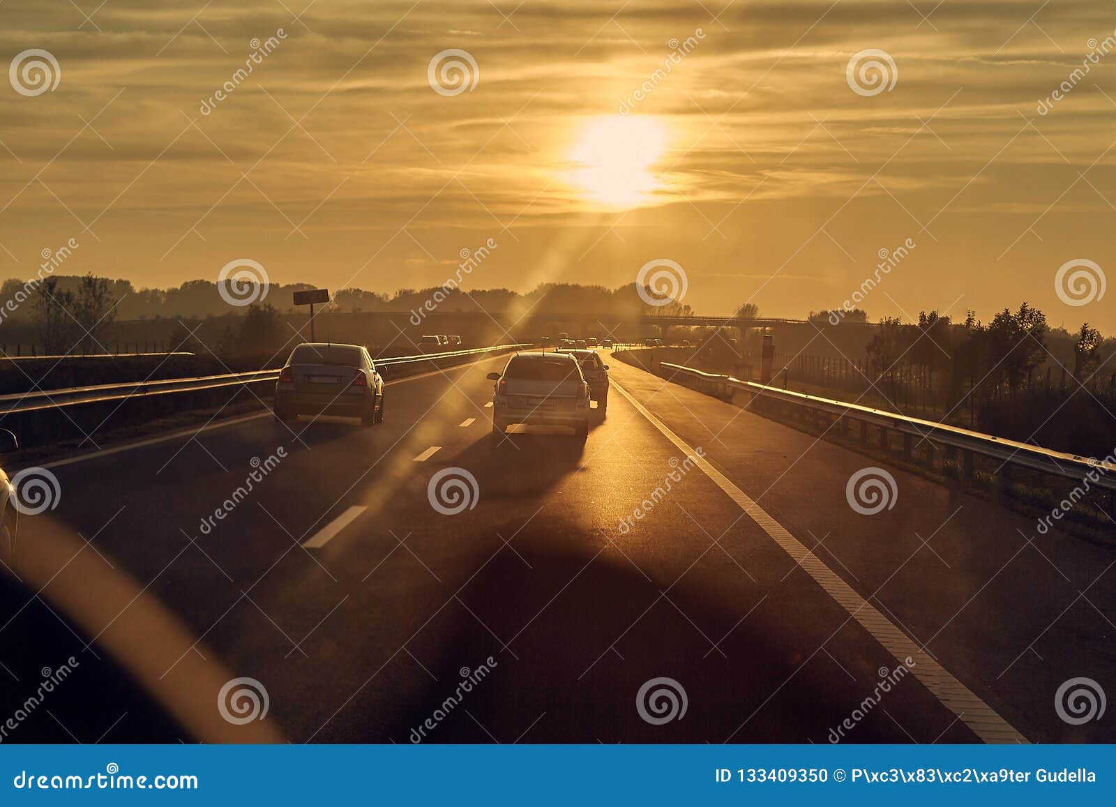 Driving in sunset stock photo. Image of driving, evening - 133409350