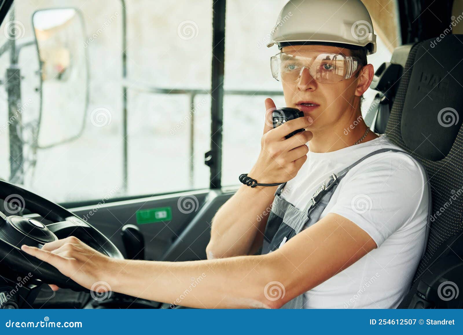 Driving Transport. Worker in Professional Uniform is on the Borrow Pit ...