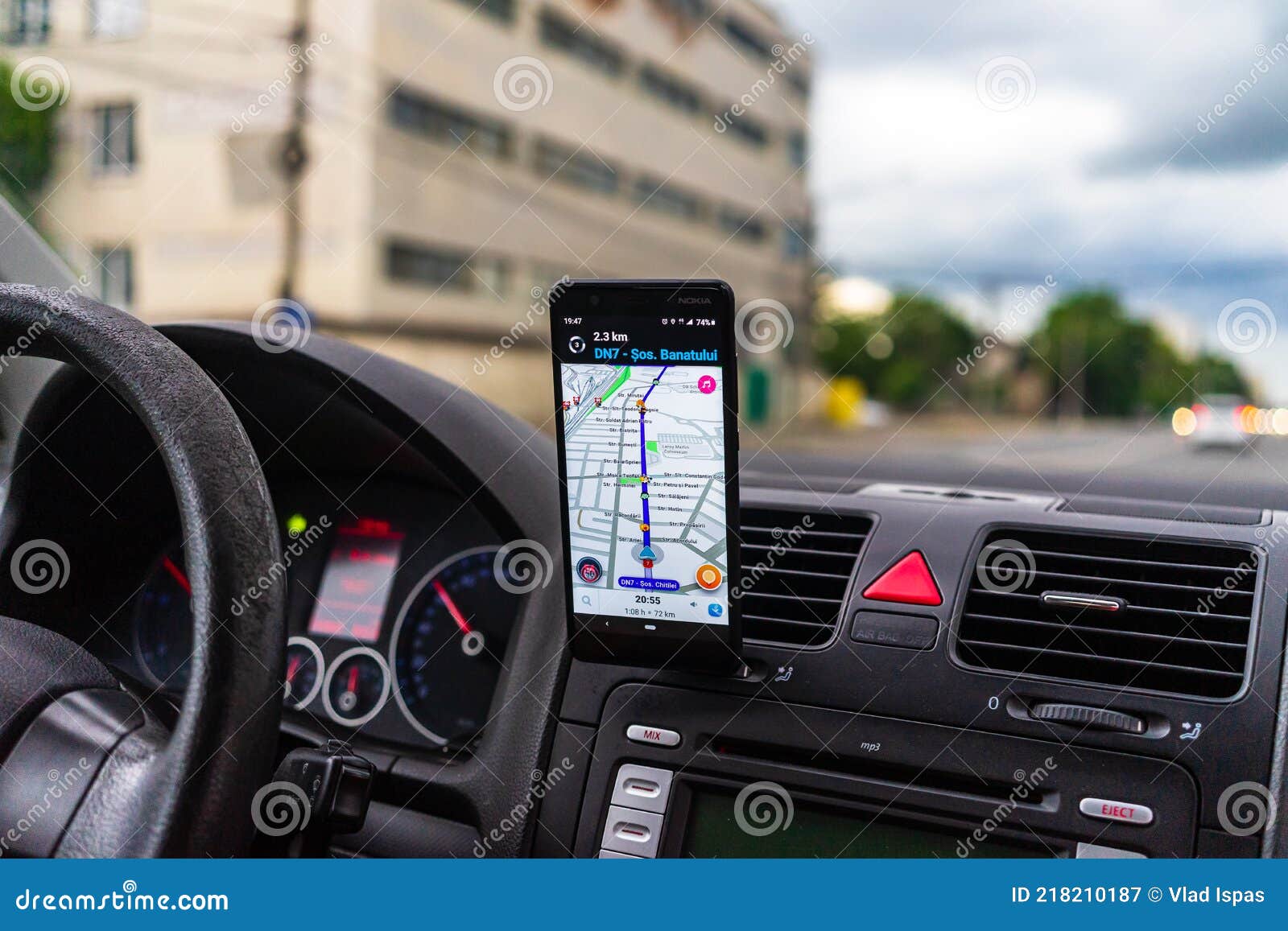 Driving and Using Waze Maps Application on Smartphone on Car Dashboard ...