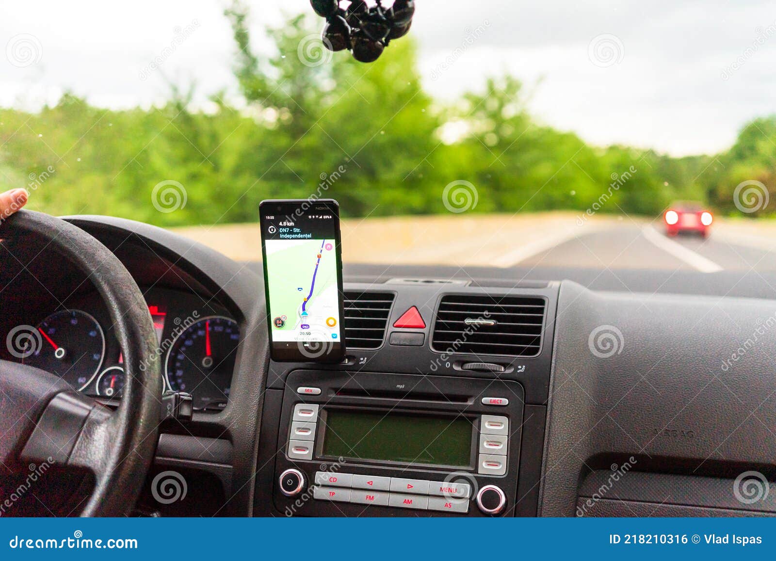 Driving And Using Waze Maps Application On Smartphone On Car Dashboard ...