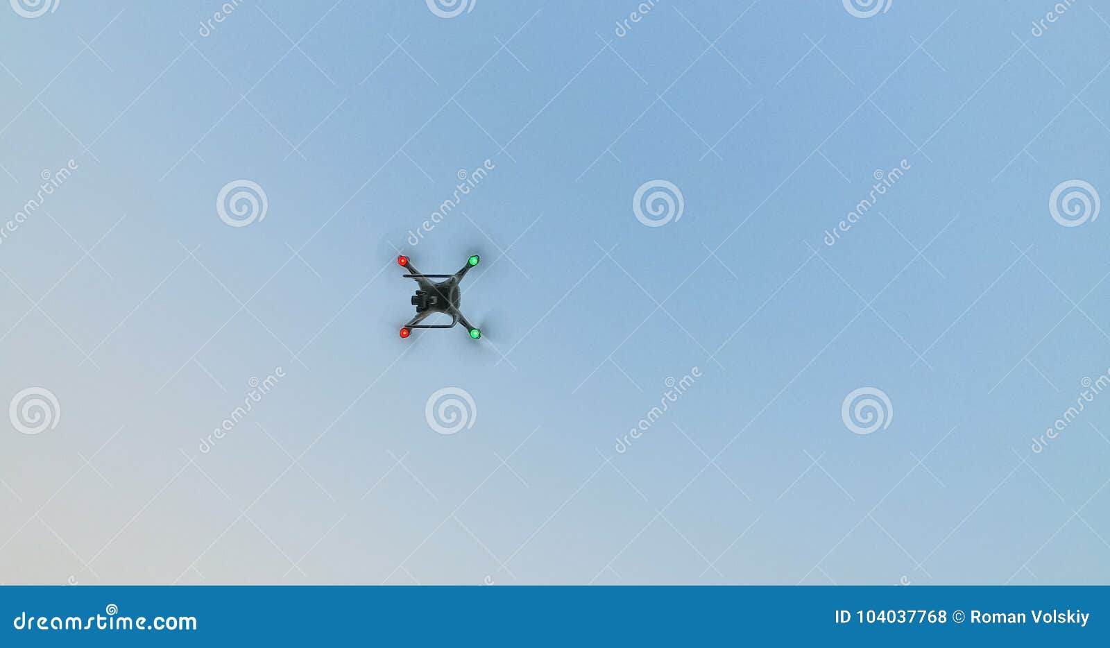 Drone with Camera Flies Overhead in the Blue Evening Sky. Stock Photo ...
