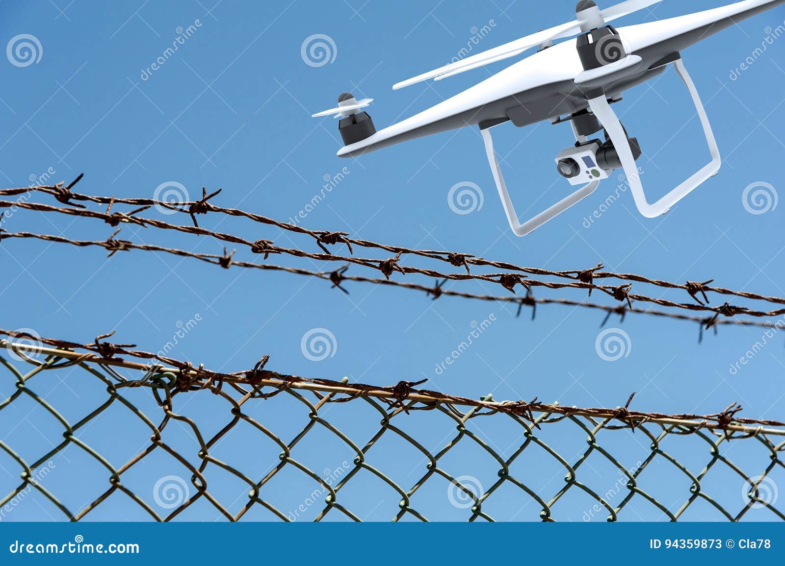 Drone with Digital Camera Flying Over a Barbed Wire Fence Stock ...