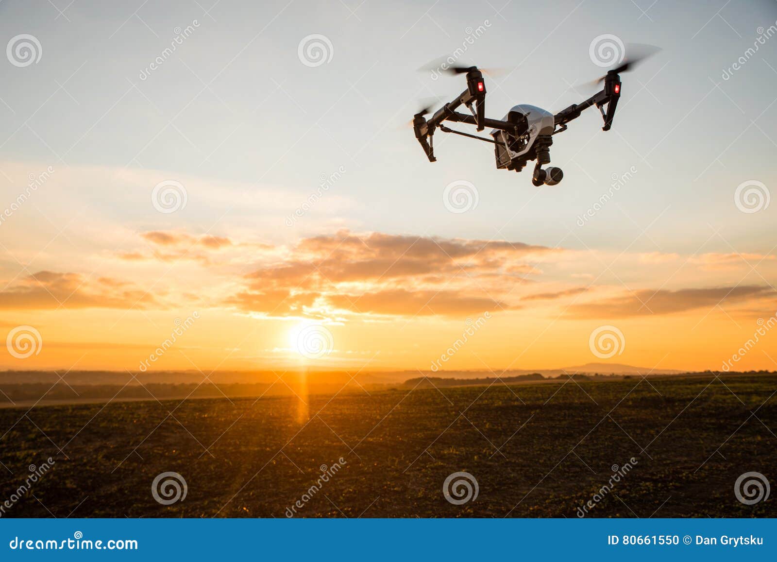 Drone with Digital Camera Flying in Sky Over Field on Sunset Stock ...