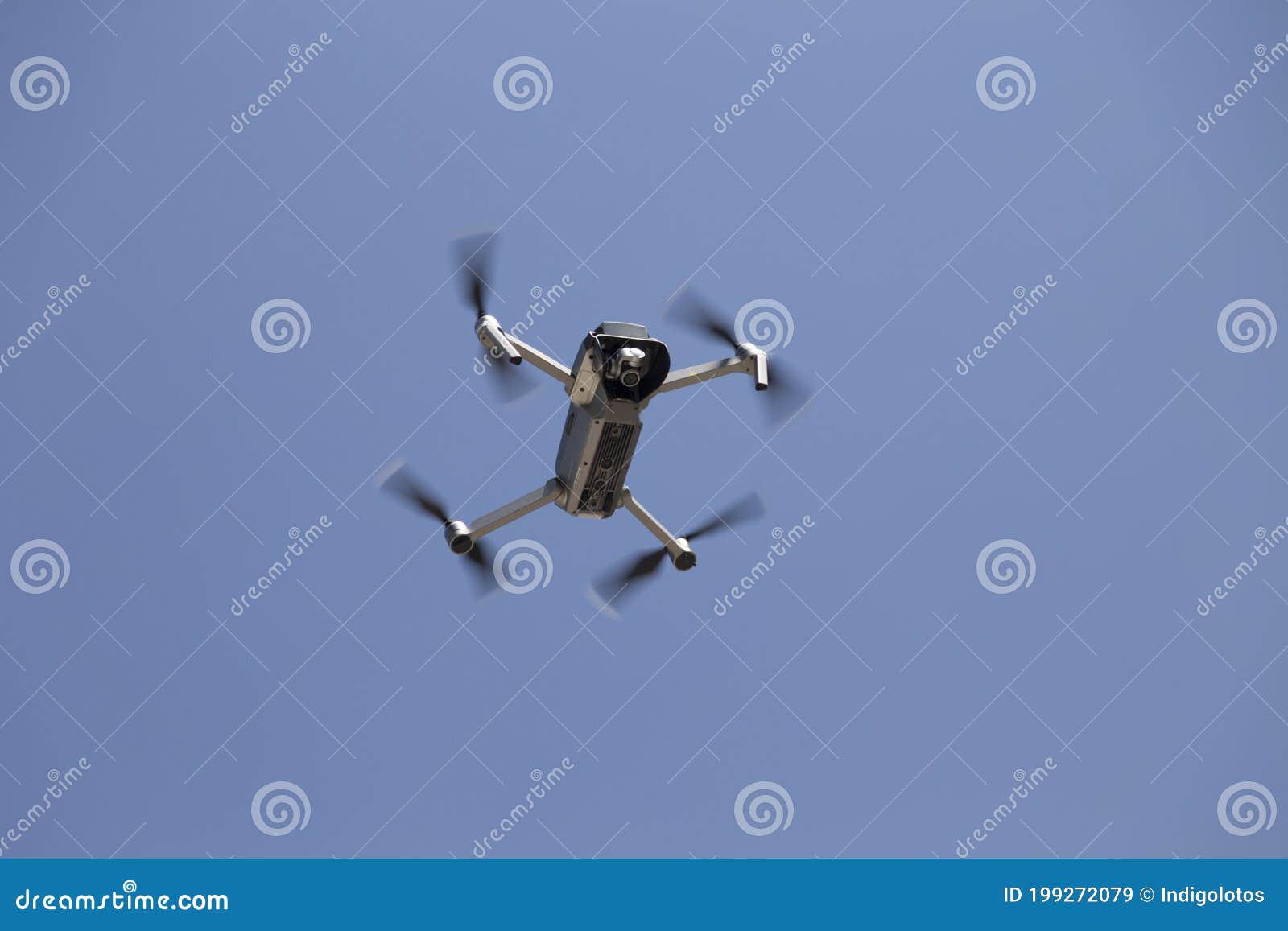 Drone Flying Overhead in Cloudy Blue Sky Stock Image - Image of copter ...