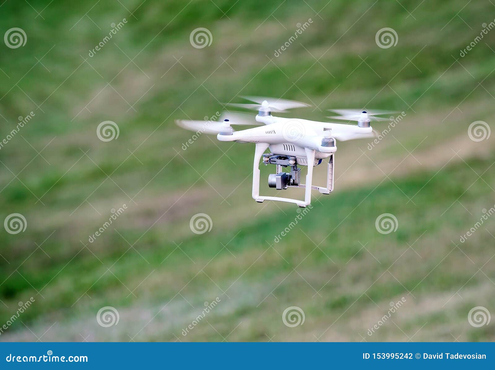 Drone Landing on Green Grass on the Field. Stock Photo - Image of ...