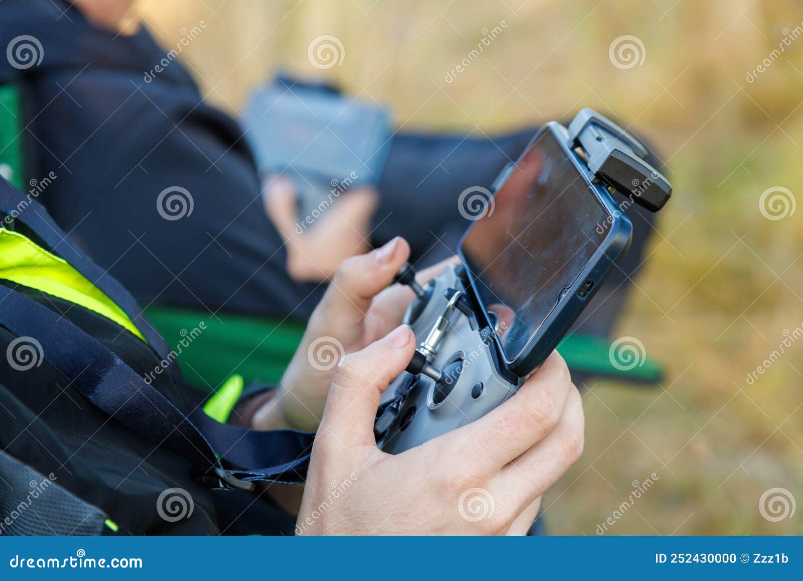 Drone Operator Hands Using Remote Control with Sticks and Cellphone As ...