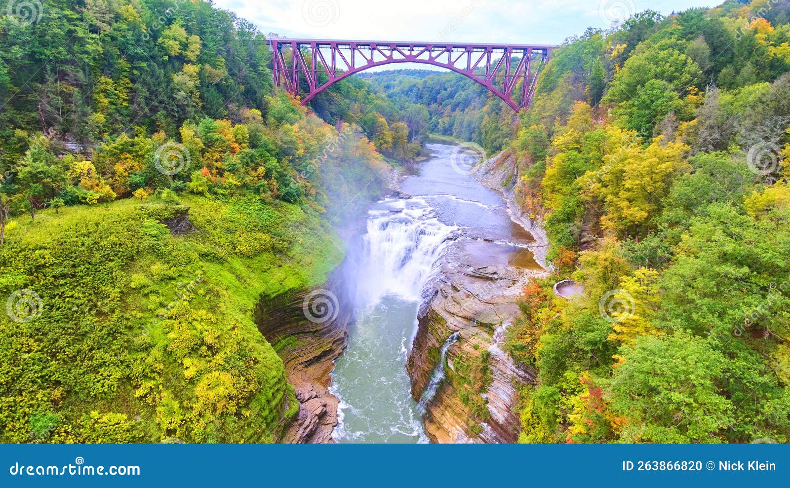 Drone Over Amazing Raging Waterfall Carving into Cliffs with Train ...
