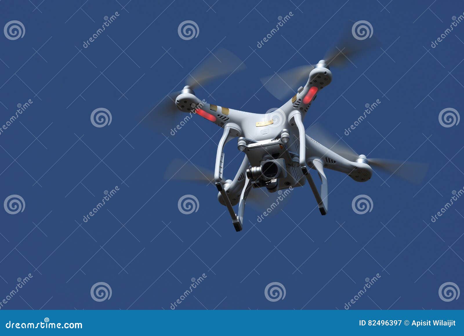 Drone Quad Copter Flying and Hovering in the Blue Sky. Editorial ...