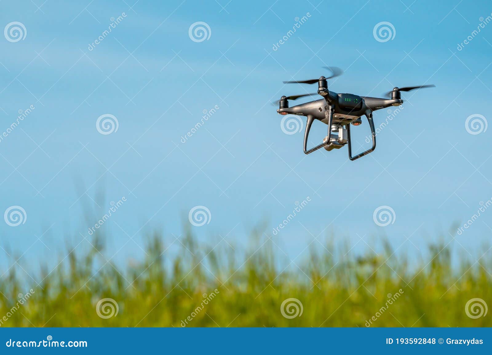 Drone Quadcopter Hovering Over Grass Field Stock Photo - Image of video ...