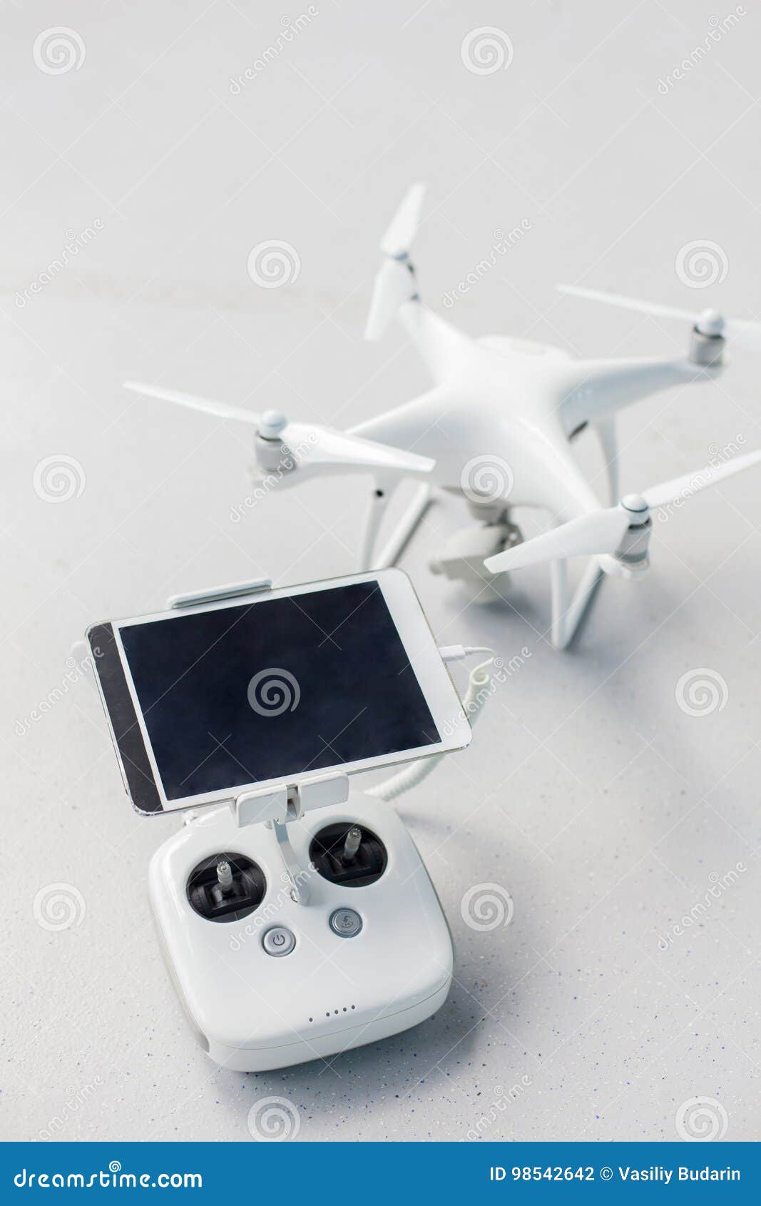 Drone with a Remote Control and a Tablet on it on a Gray Concrete ...