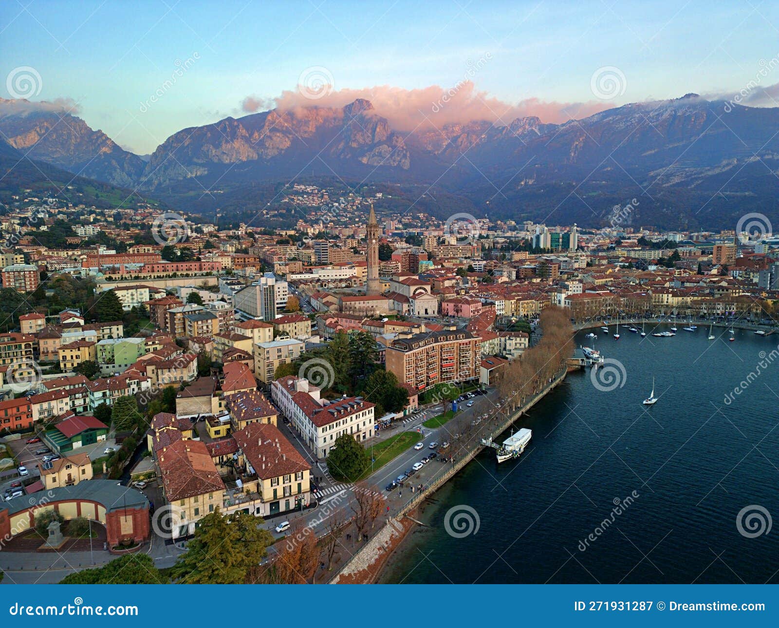 Drone View of Lake Como Surrounded by a Town and Mountains in the ...