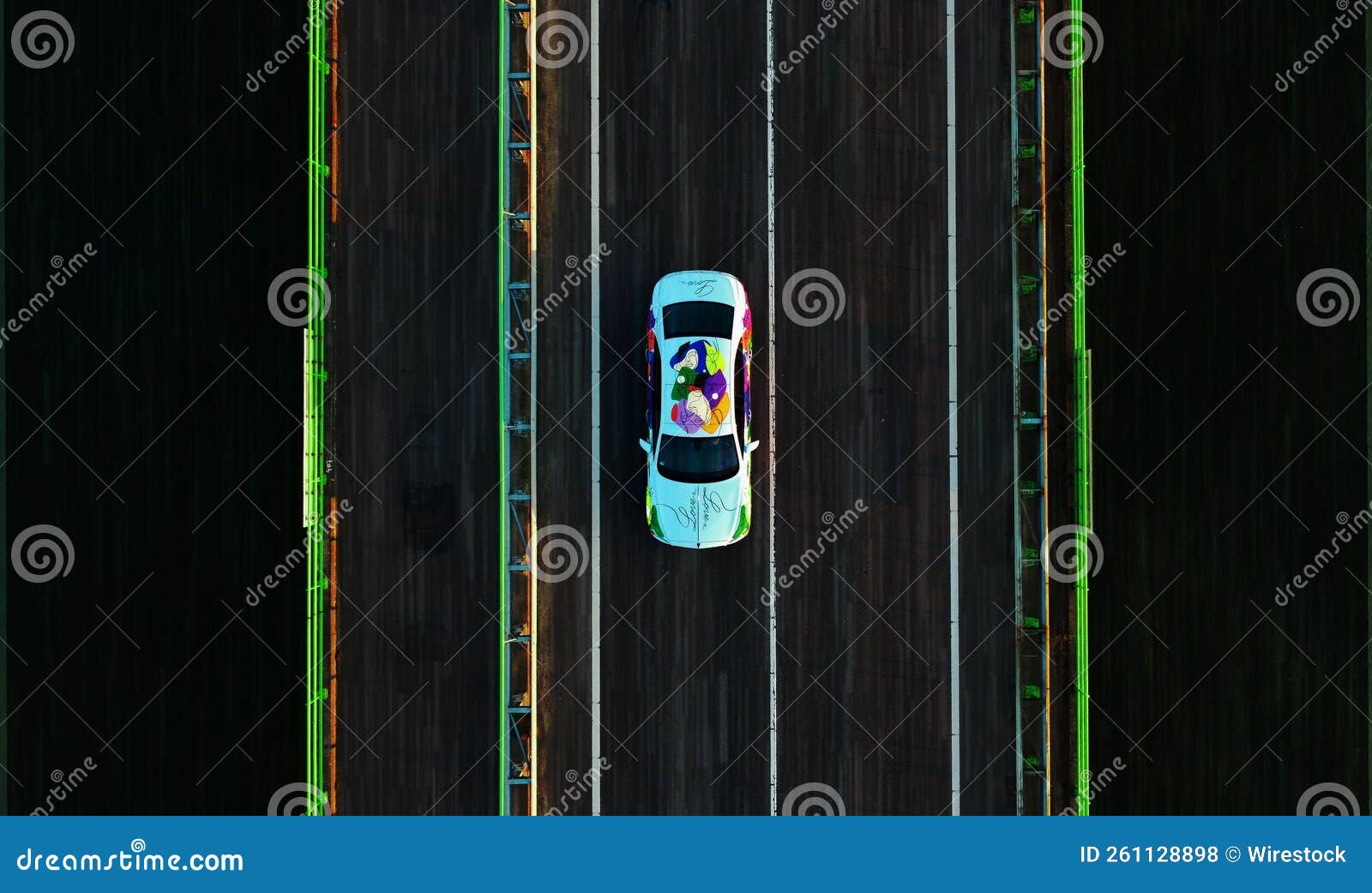 Drone View of a Painted White Bentley Unifying Spur Car Driving on a ...