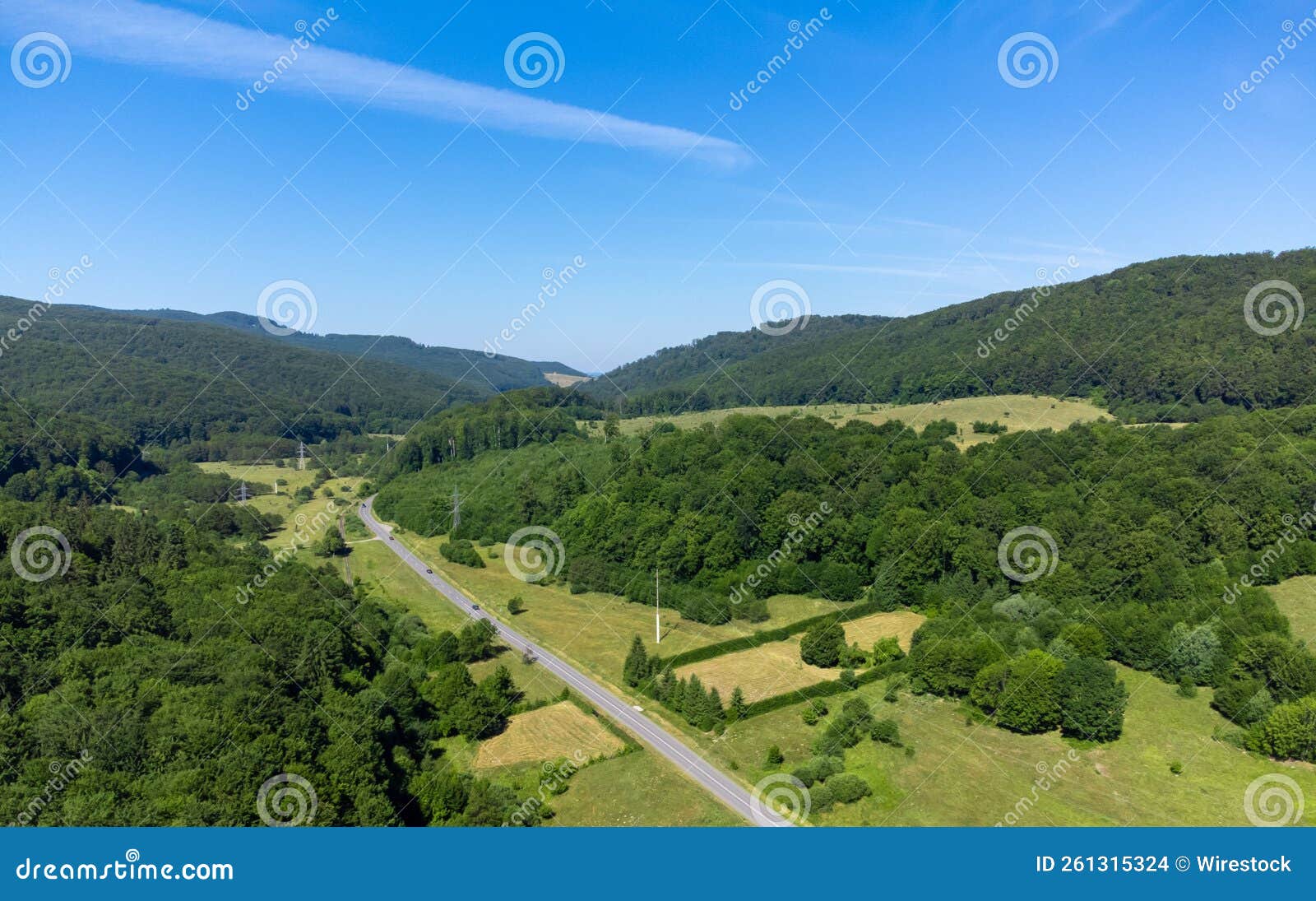 Drone View of a Road among Green Hills and Forests Stock Photo - Image ...