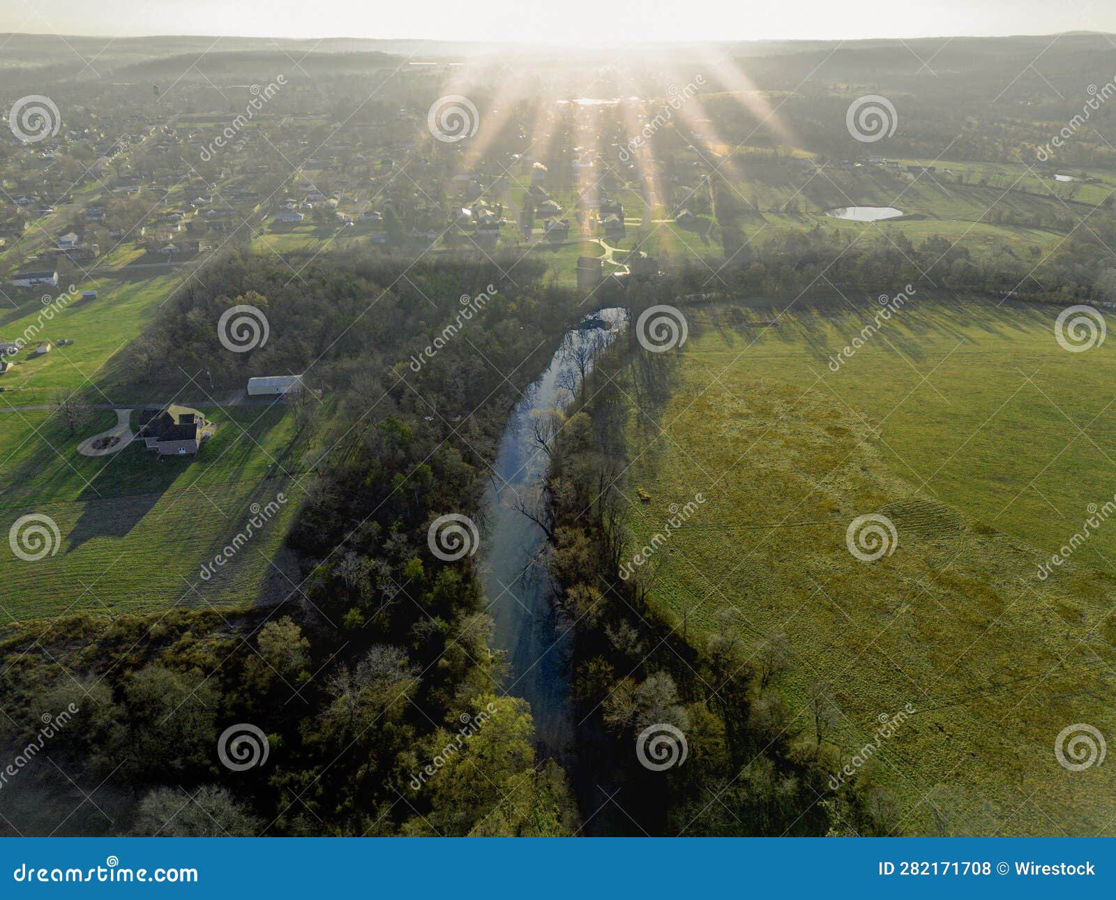 Drone View of a Stream Flowing through Farm Fields Under the Sunlight ...