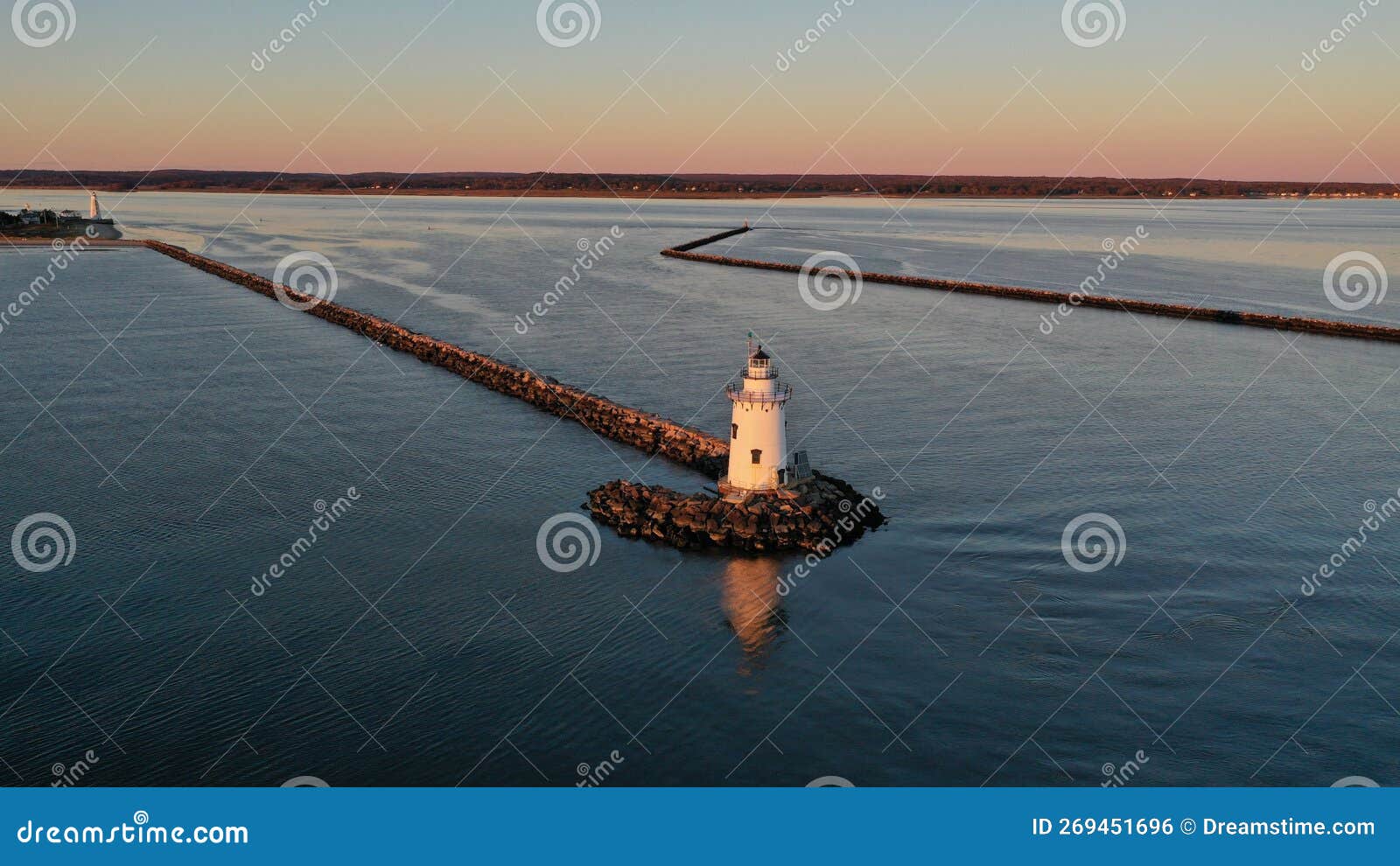 Drone View of the White Lighthouse Reflected on the Sea Illuminated by ...