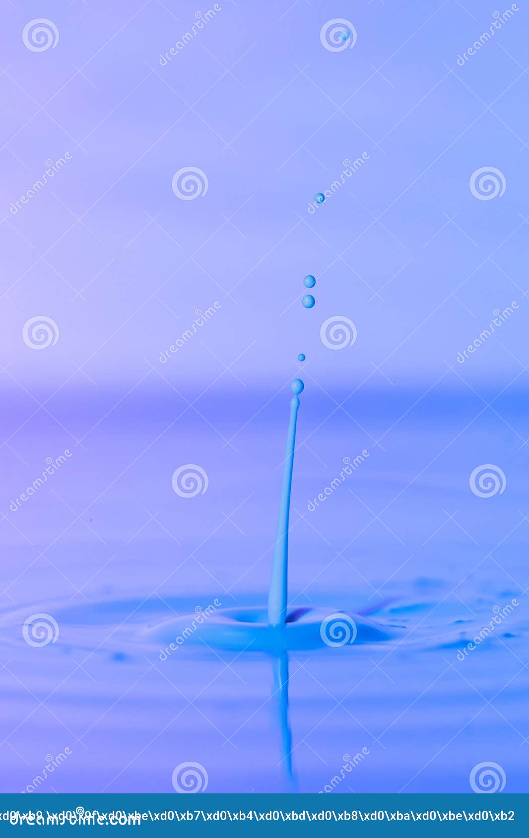 A Drop Falls into a Thick Liquid with a Blue Background. Abstract ...