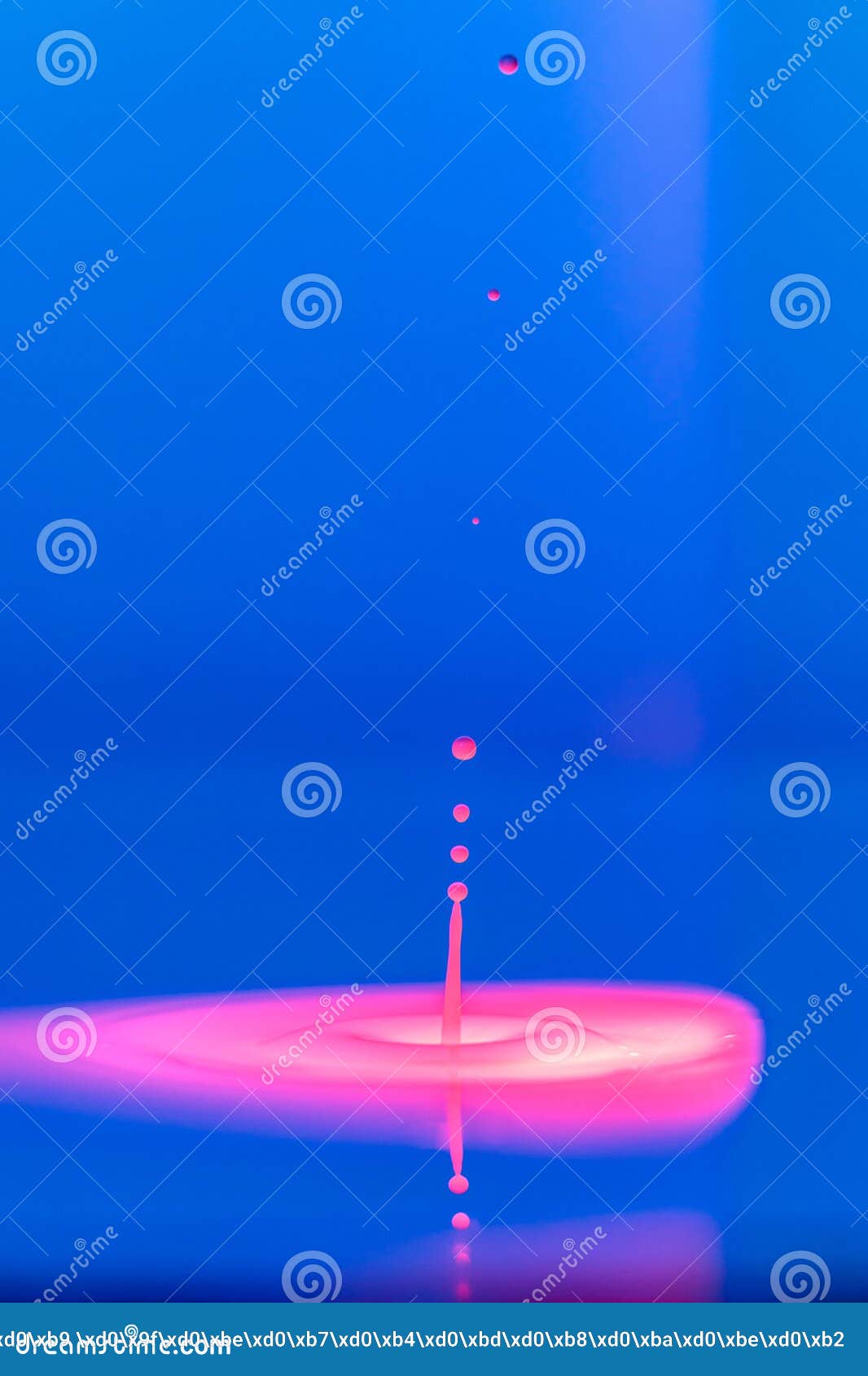 A Drop Falls into a Thick Liquid with a Blue-pink Background. Abstract ...