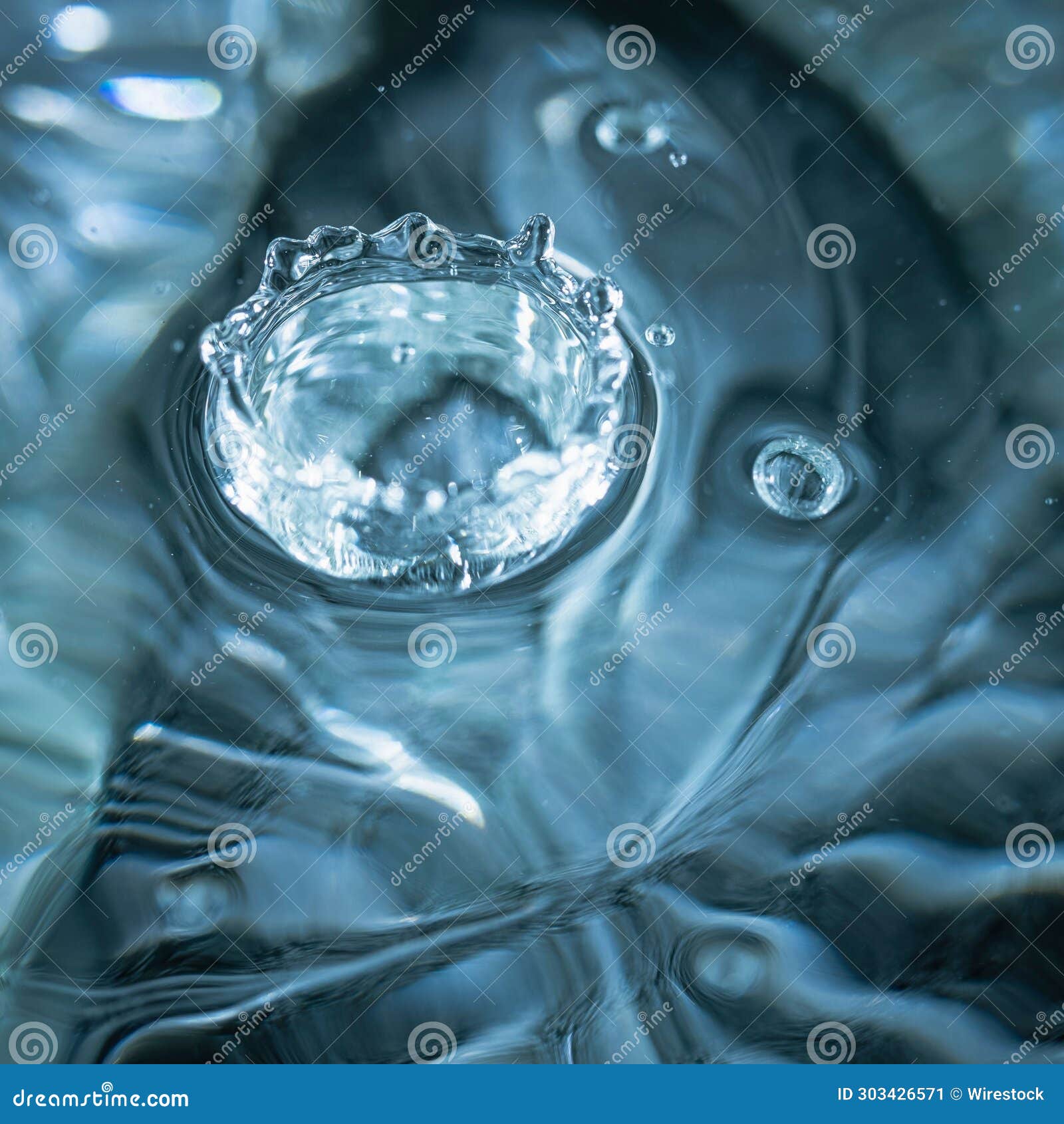 Drop of Liquid Falling into a Clear Glass Container Full of Water Stock ...