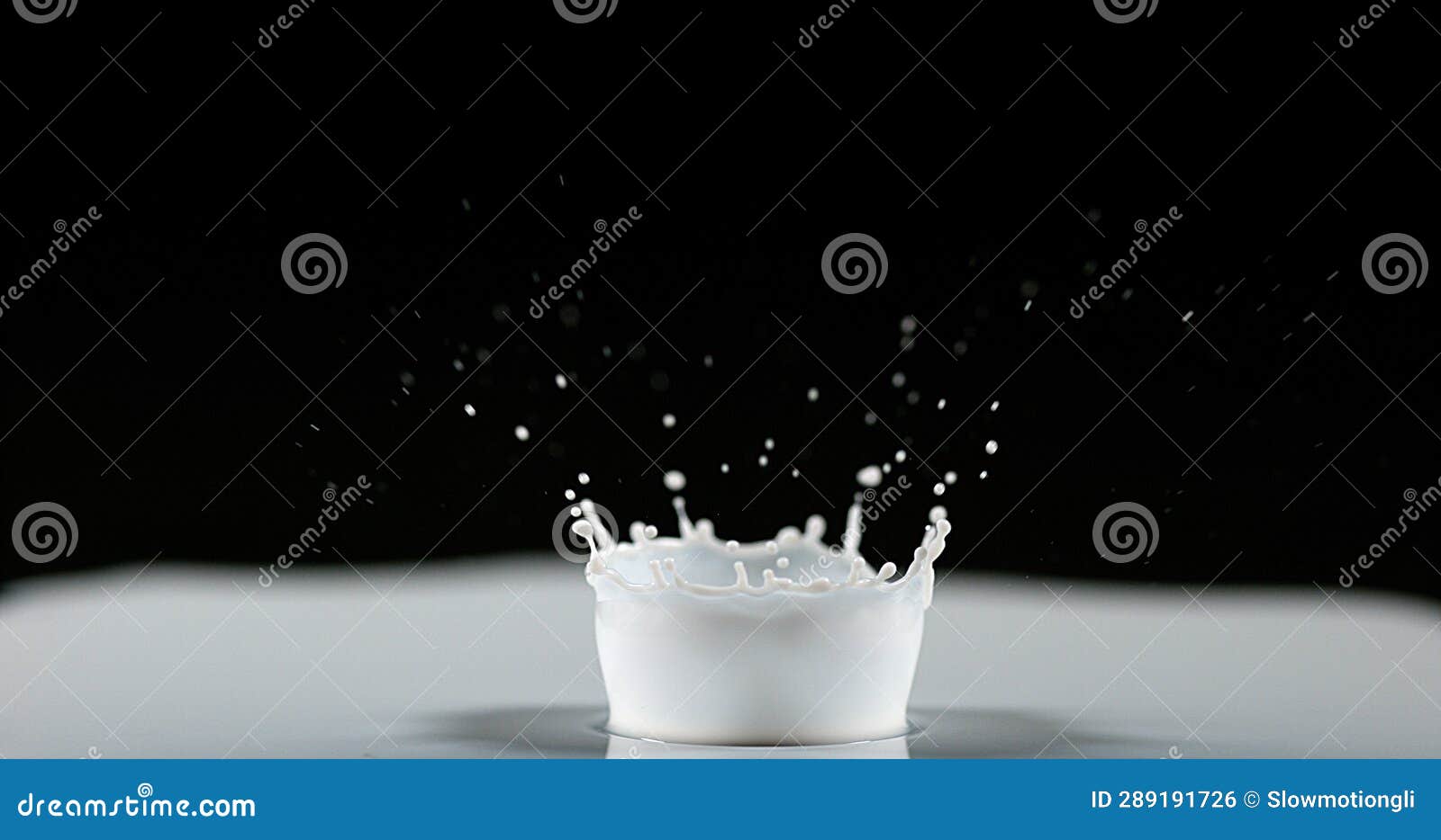 Drop of Milk Falling Against Black Background Stock Photo - Image of ...