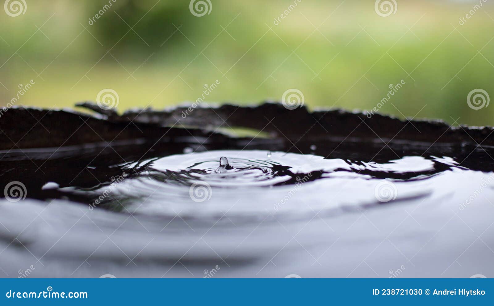 A Drop of Pure Rainwater Falling into a Container Stock Photo - Image ...