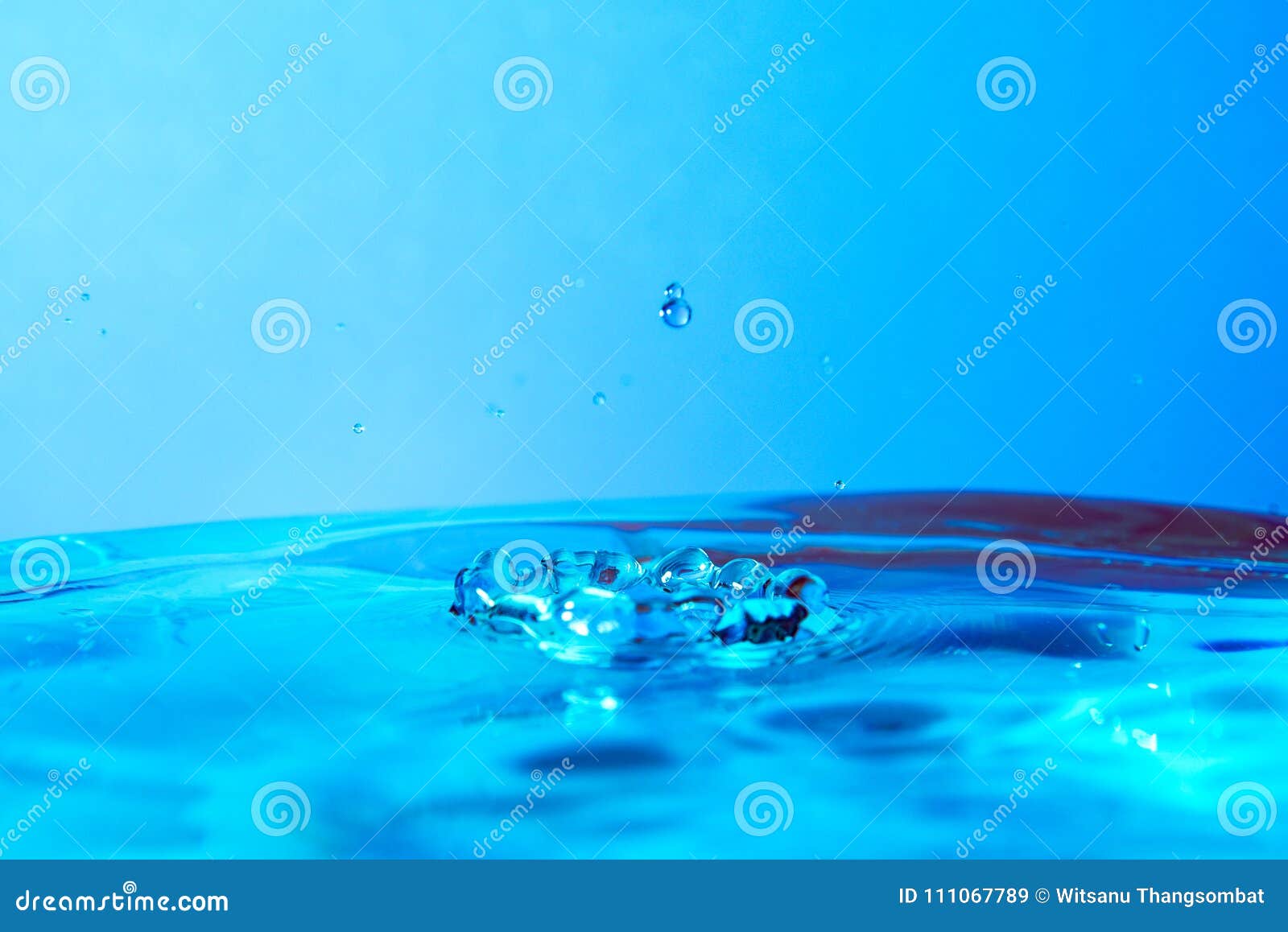 Drop of Water Falling in Blue Water and Blue Background. Stock Image ...