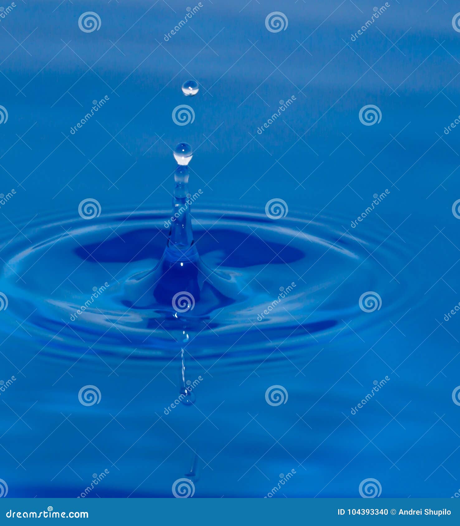 A Drop of Water Falling in Blue Water Stock Photo - Image of rain, rays ...