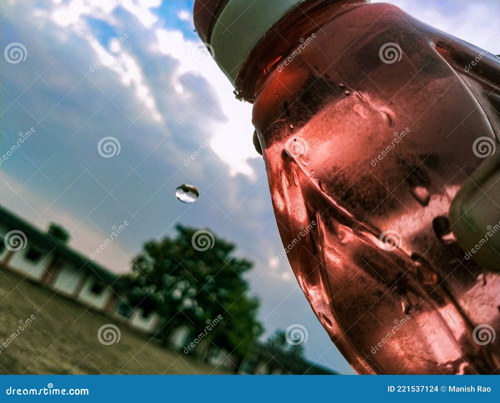 A Drop of Water is Falling Down through Bottle Which is Full of Water ...