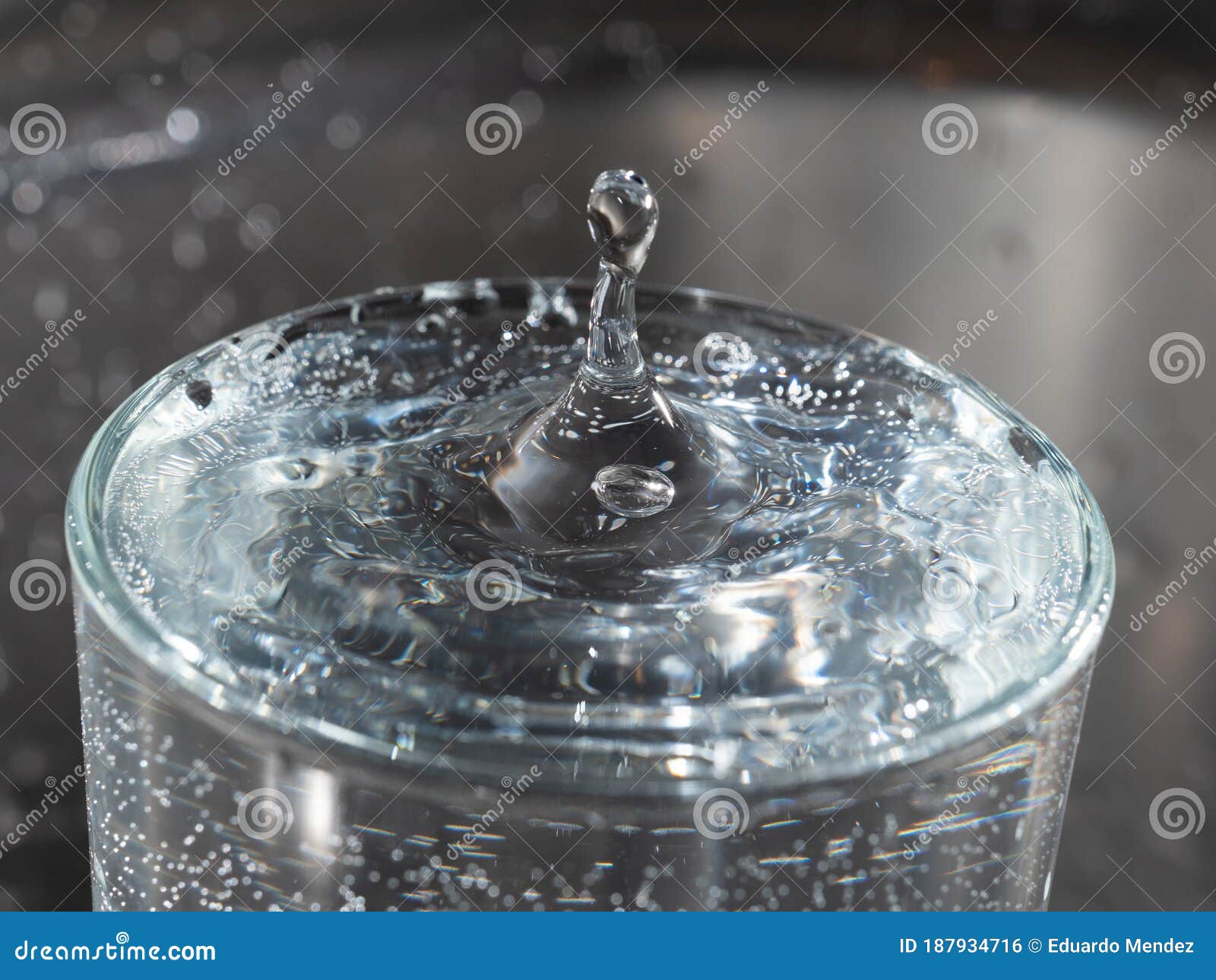 A Drop of Water Falling into a Glass Stock Photo - Image of flowing ...
