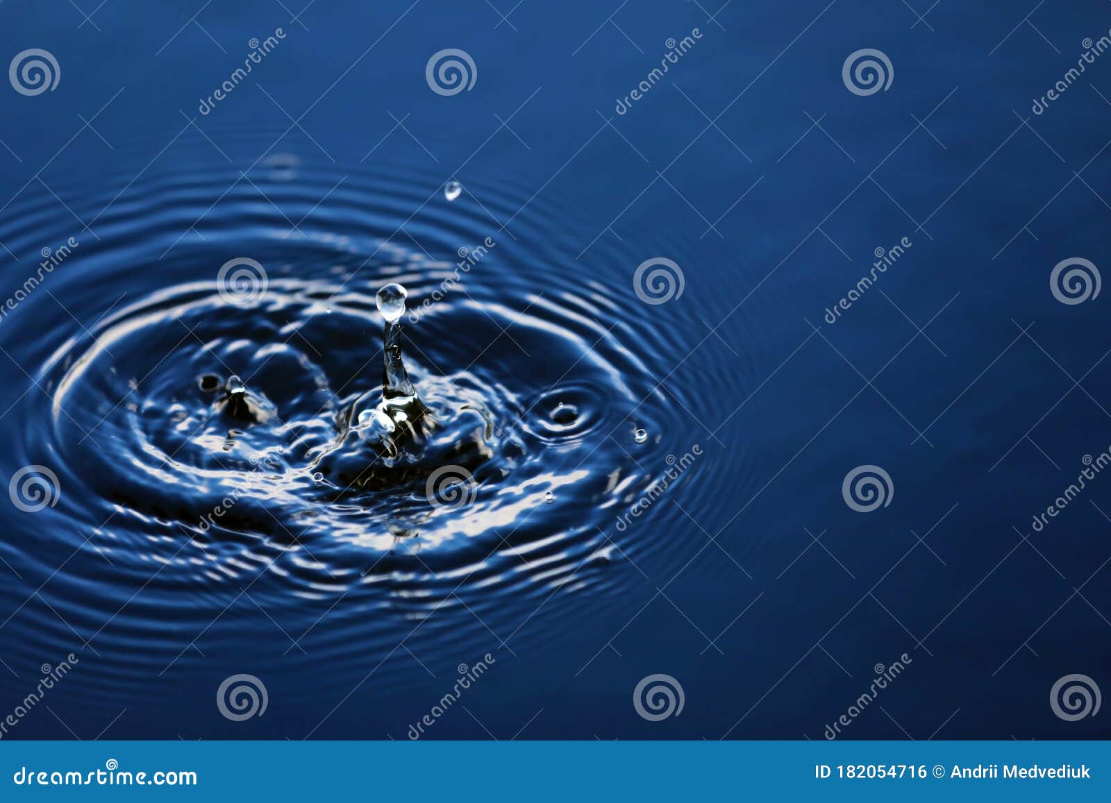 A Drop of Water Falls into the Water, Making a Perfect Splash of Drops ...