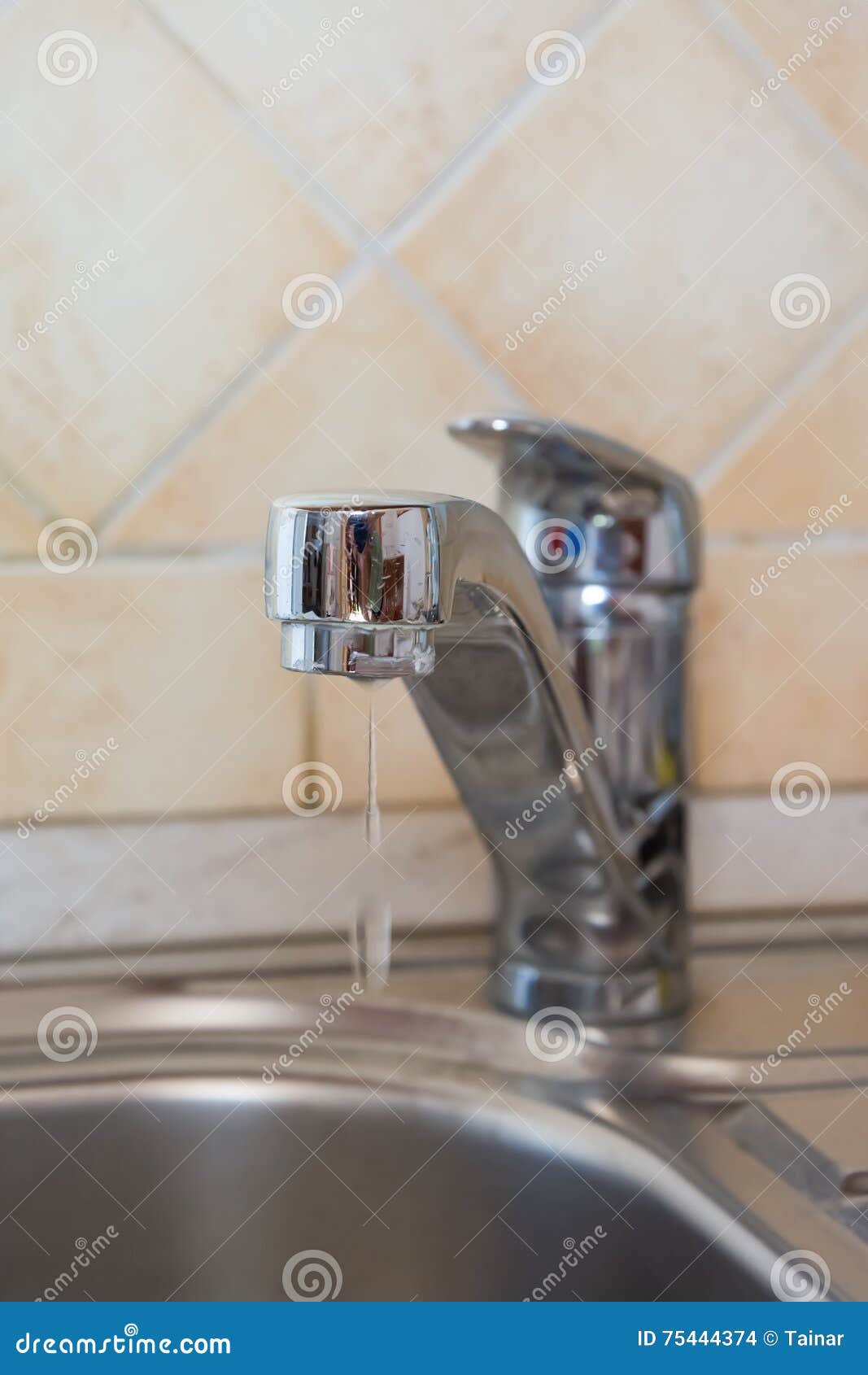 A drop of water on a tap stock photo. Image of household - 75444374