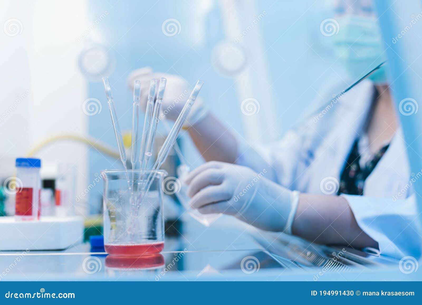 Dropper Pipette in Beaker and Scientist Using Dropper Pipette Transfer ...