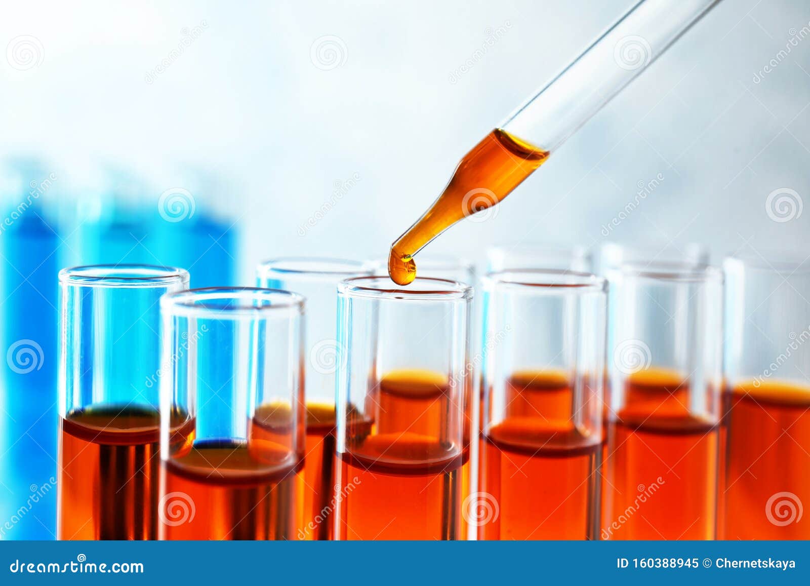 Dropping Sample into Test Tube with Orange Liquid Stock Image - Image ...