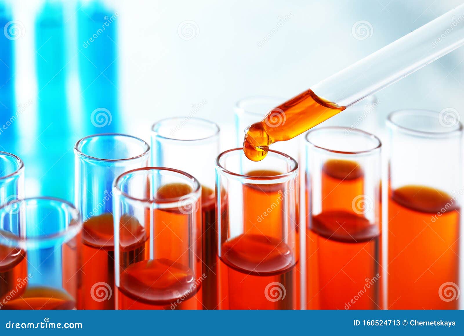 Dropping Sample into Test Tube with Orange Liquid Stock Image - Image ...