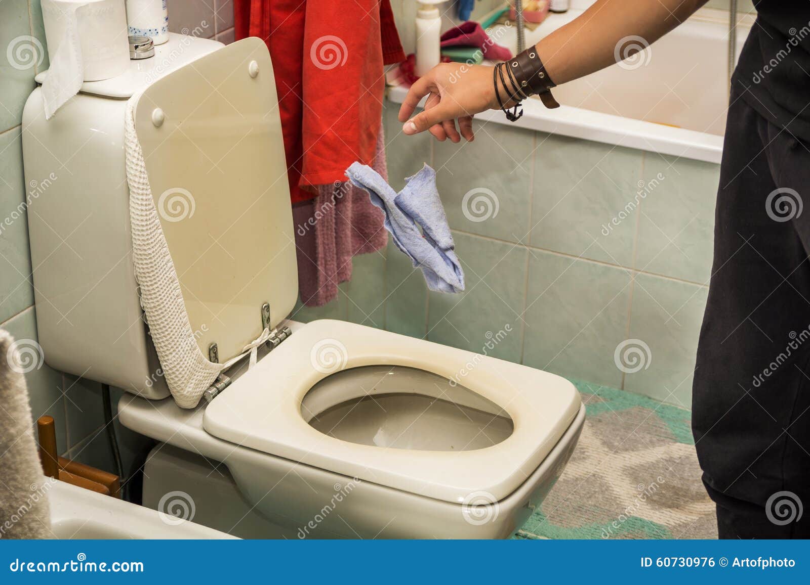 Dropping Tissue into Toilet Stock Photo - Image of tissue, wrist: 60730976