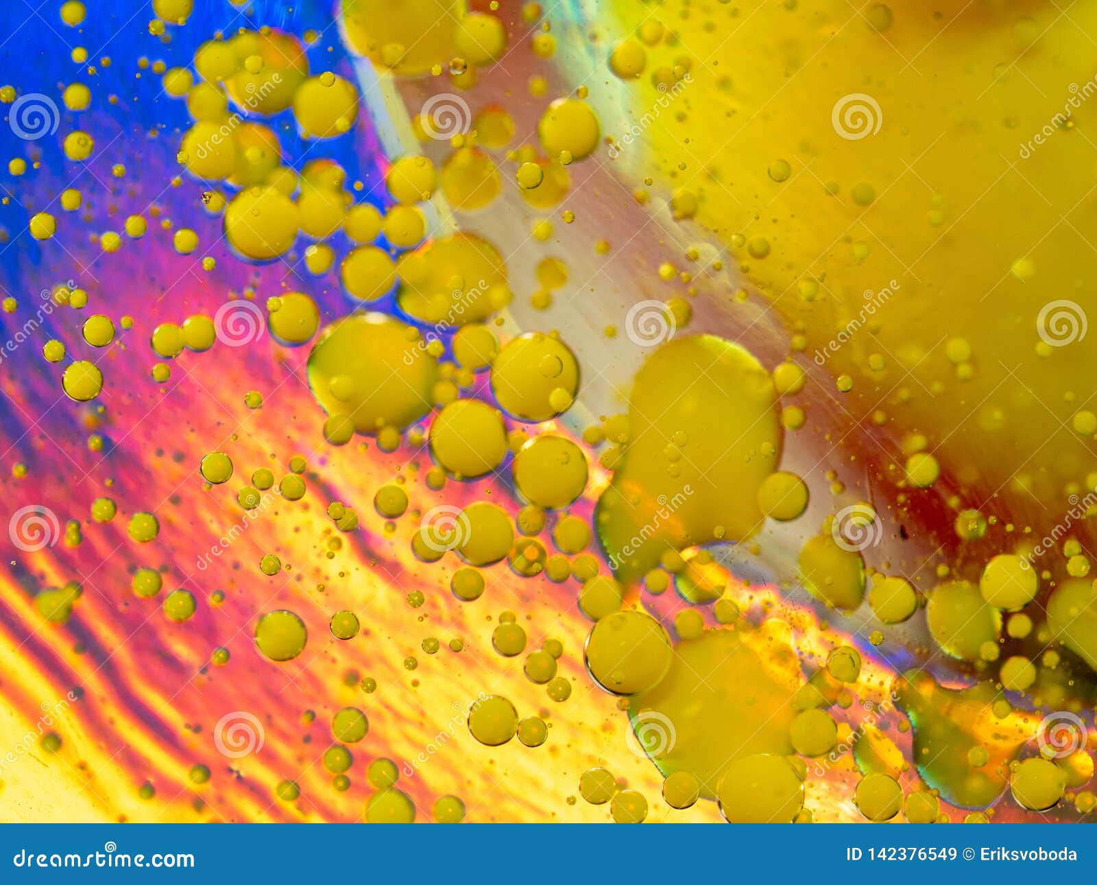 Drops of Yellow Paint on Multicolour Abstract Background. Close Up ...