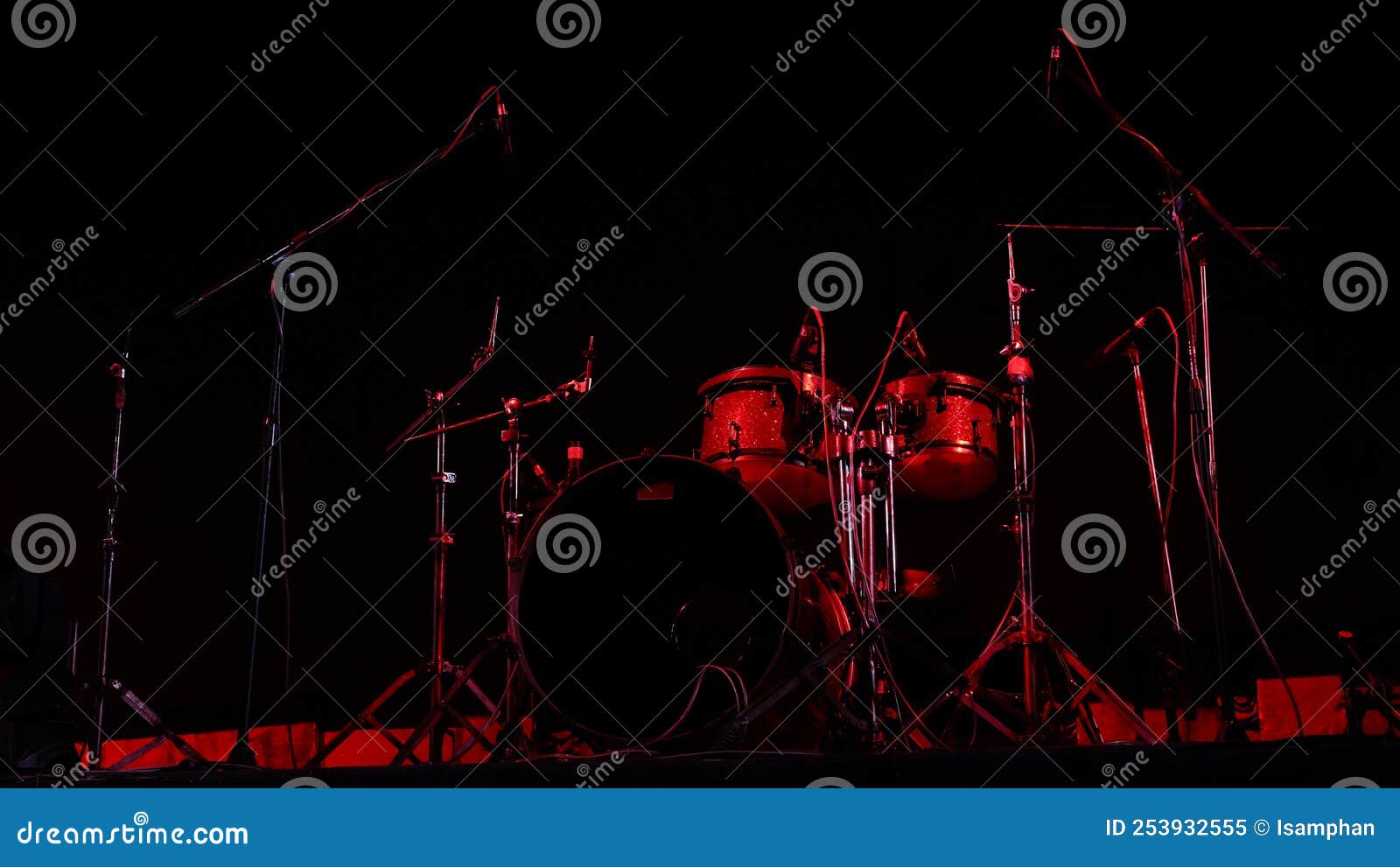 A Drum Set on a Musical Stage Illuminated by Red Neon Lights Stock ...