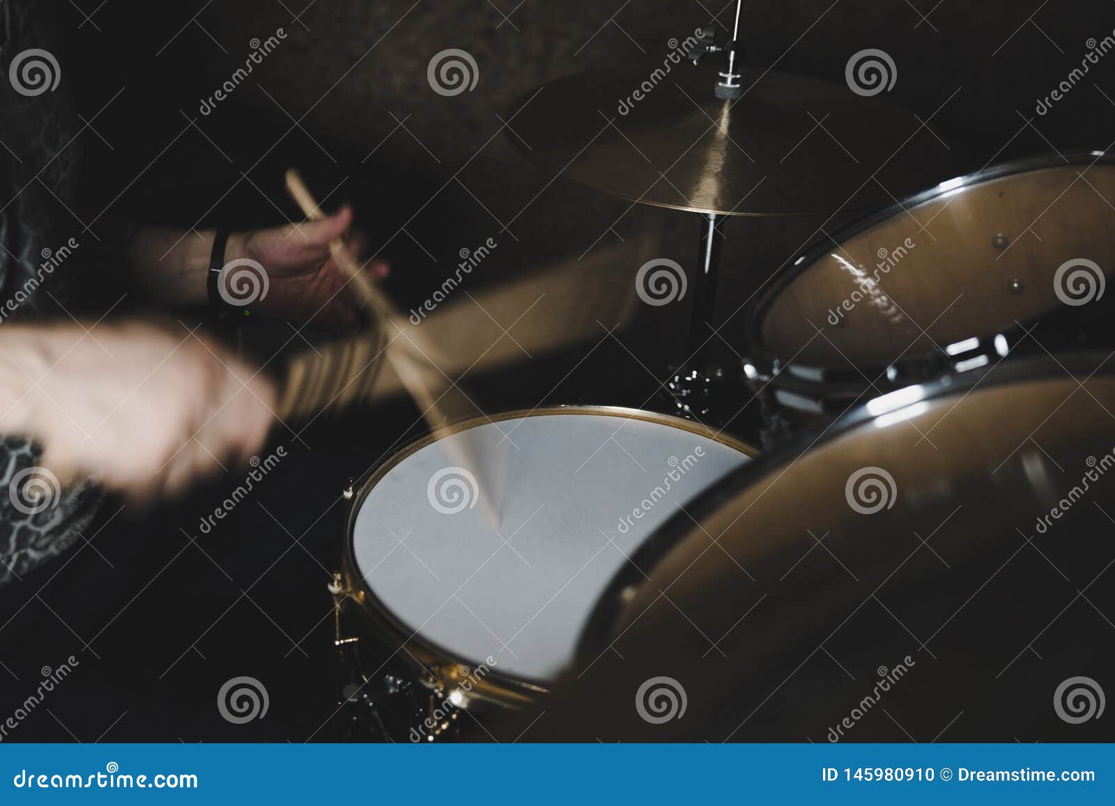 Drummer playing a drum kit stock photo. Image of playing - 145980910