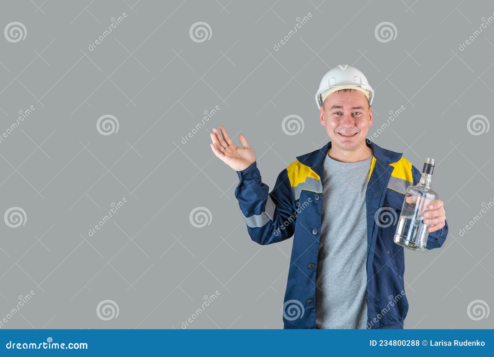 Drunk Construction Worker in Work Clothes and Hardhat Holds a Bottle of ...